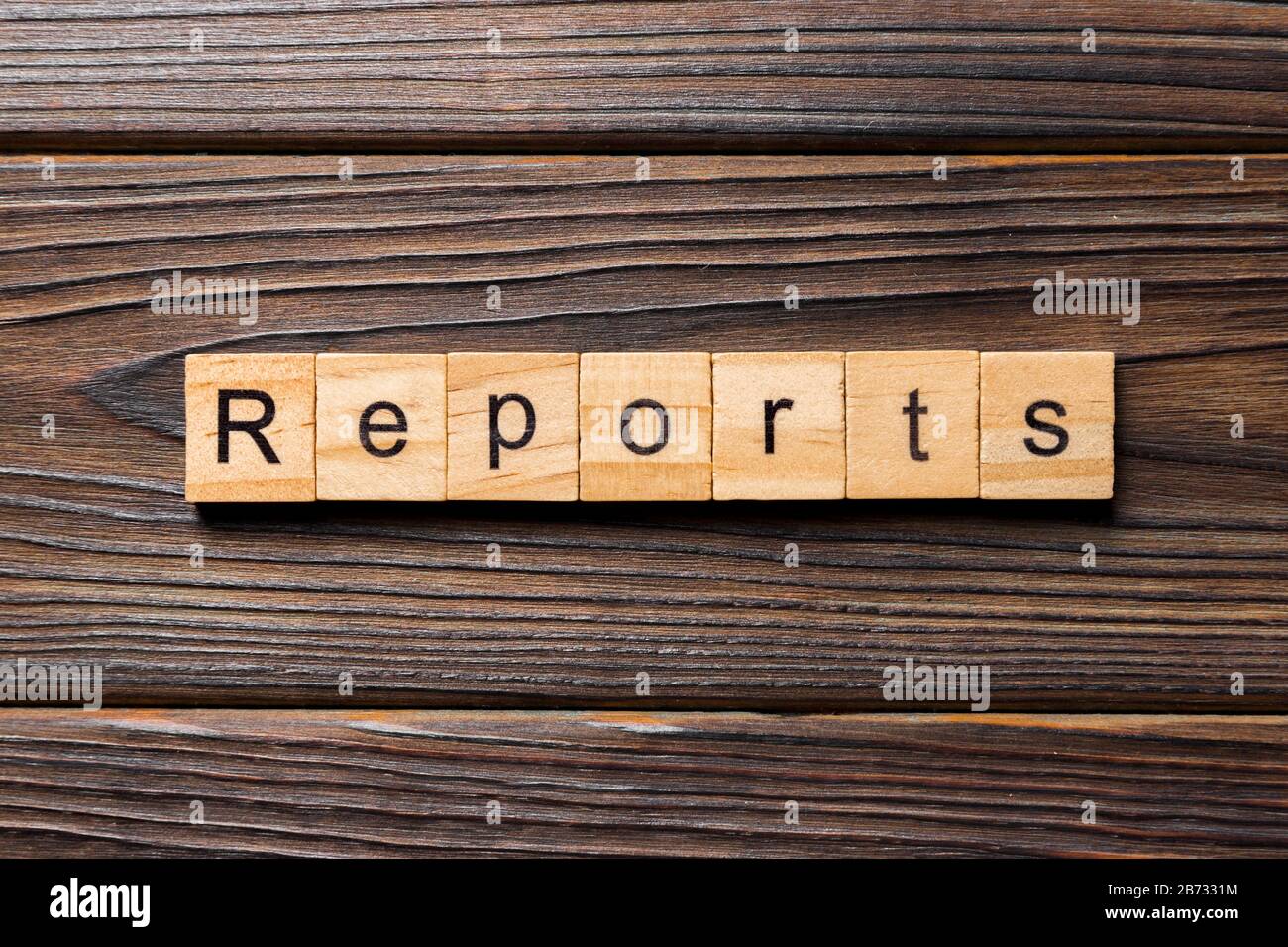 REPORTS word written on wood block. REPORTS text on table, concept ...