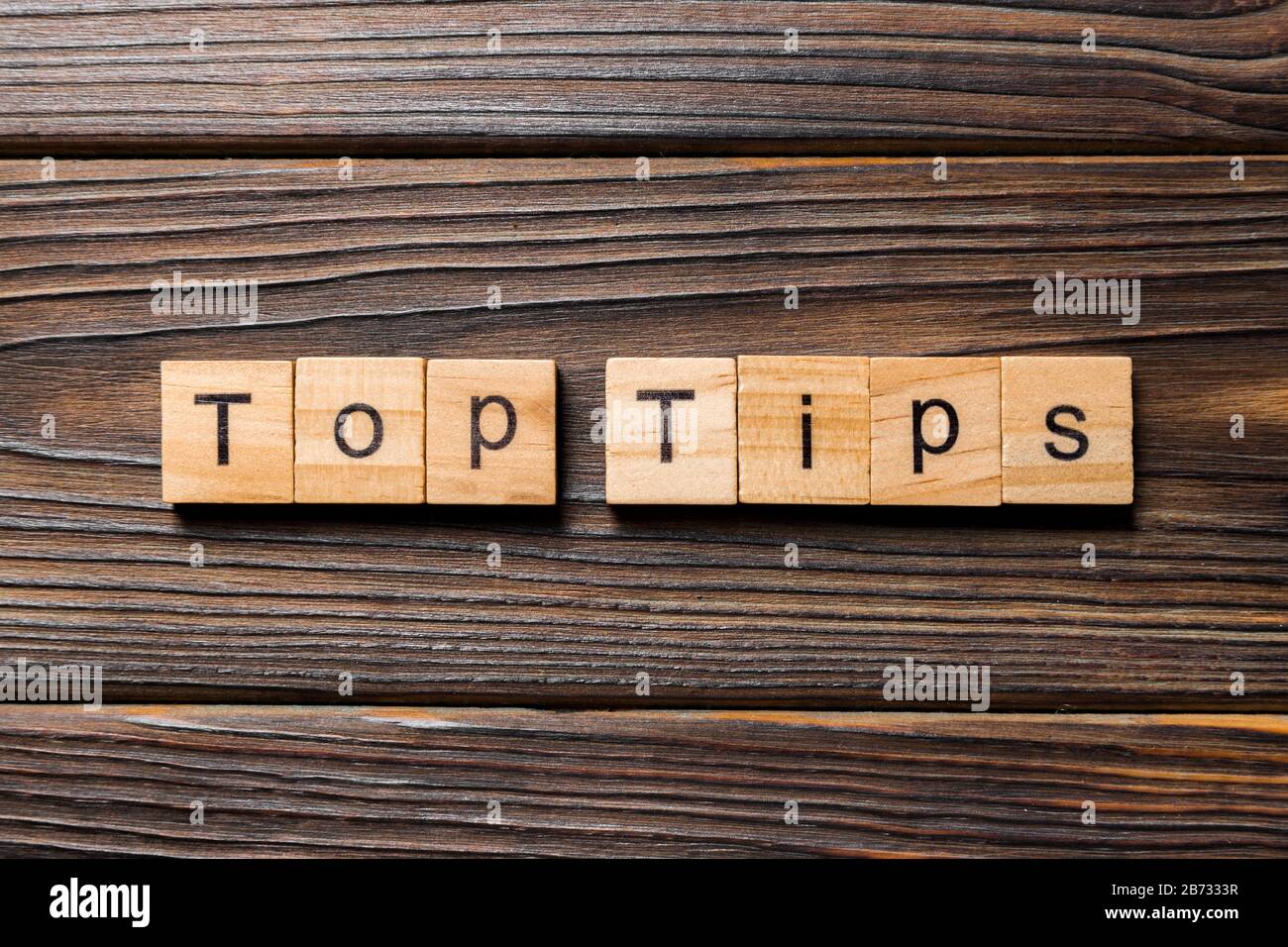 Top tips word written on wood block. Top tips text on wooden table for ...