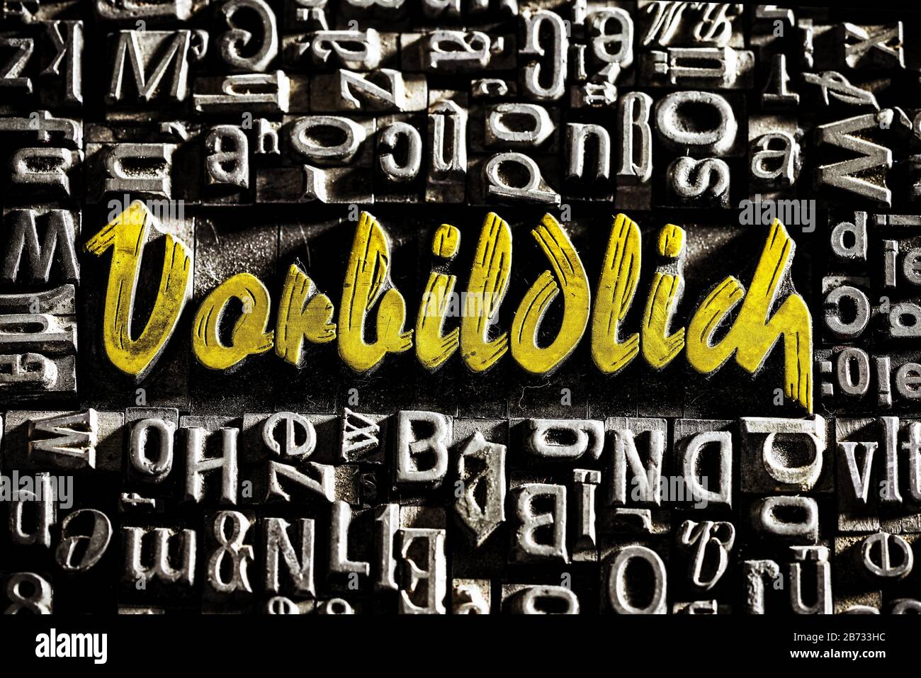 Old lead letters with golden writing show the word "Vorbildlich ...