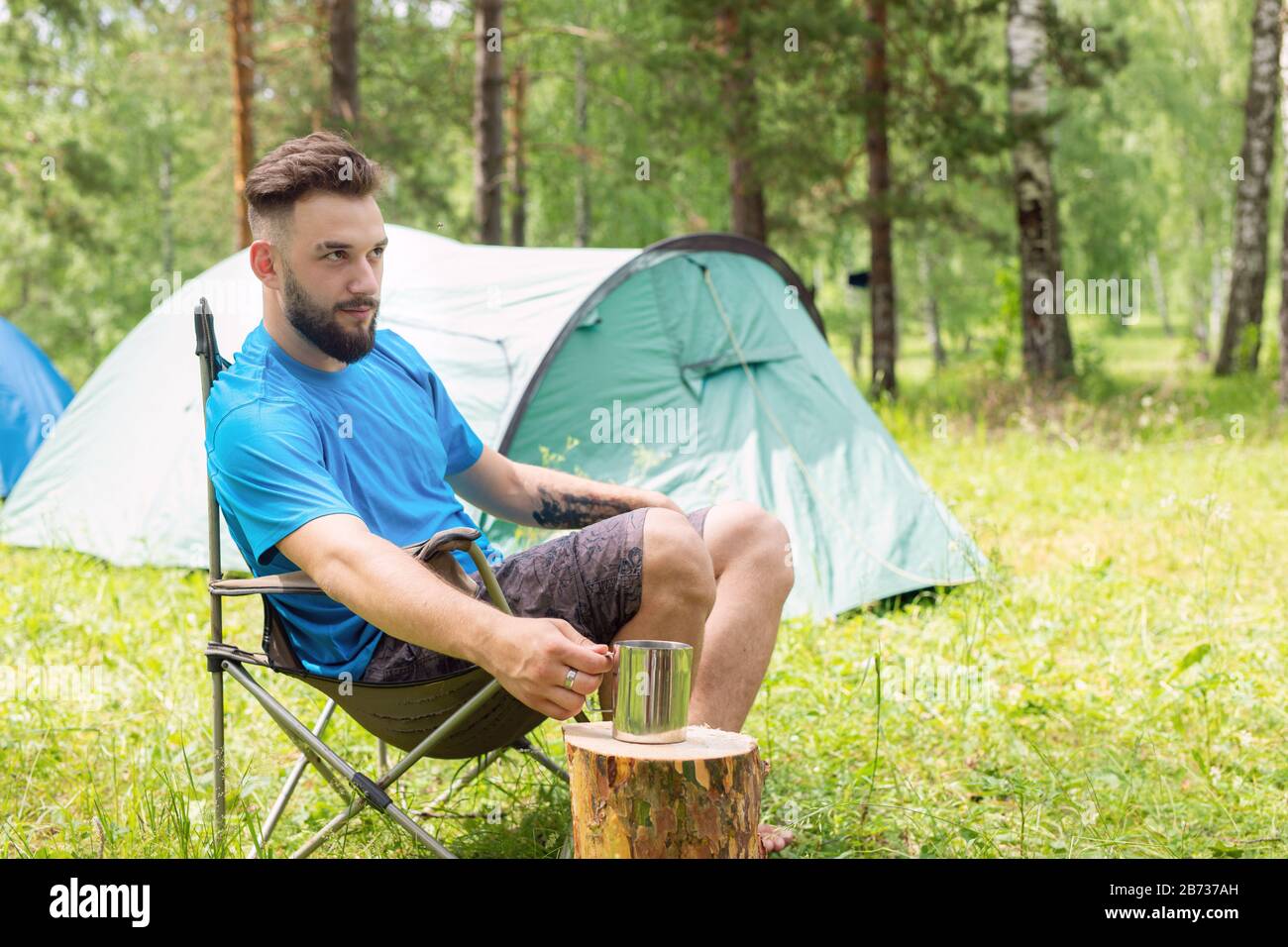 Tourist man setting camping tent hi-res stock photography and images ...