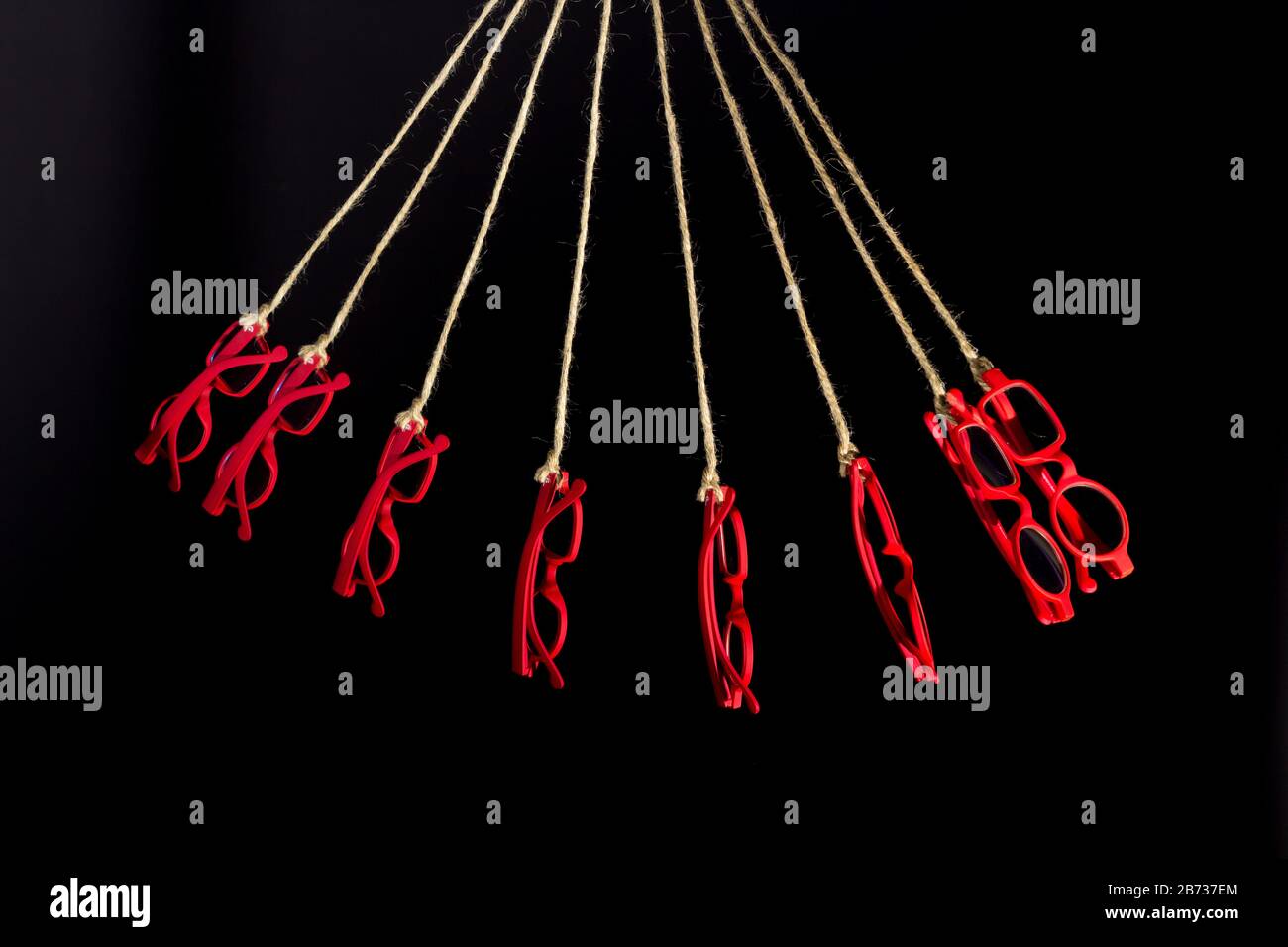 Glasses hanging on a string, several images of the same glasses that ...