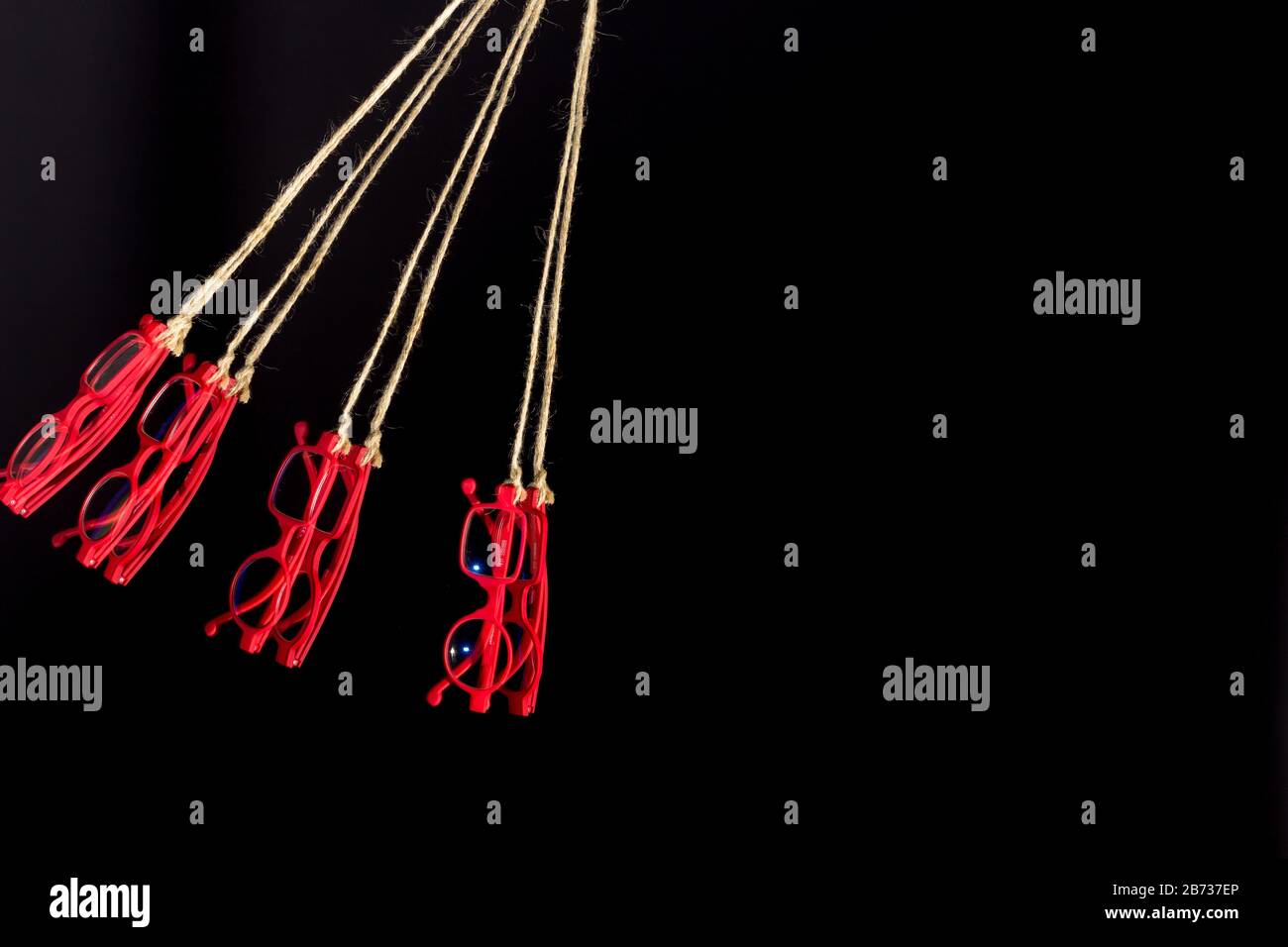 Glasses hanging on a string, several images of the same glasses that ...