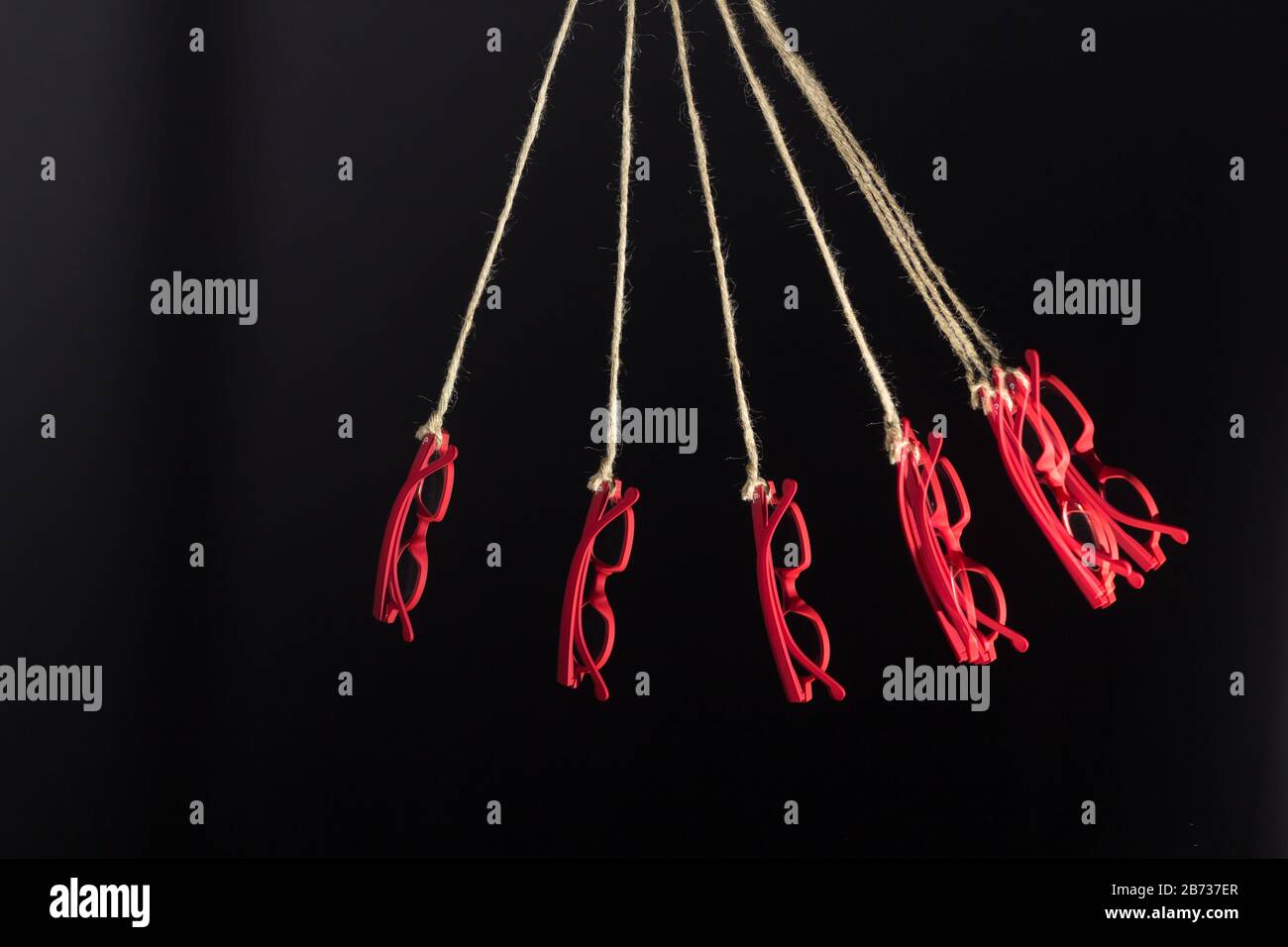 Glasses hanging on a string, several images of the same glasses that ...