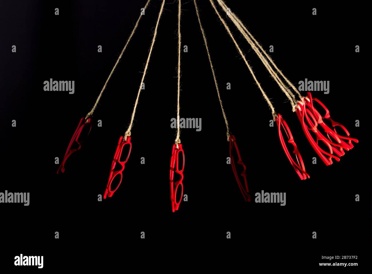 Glasses hanging on a string, several images of the same glasses that ...