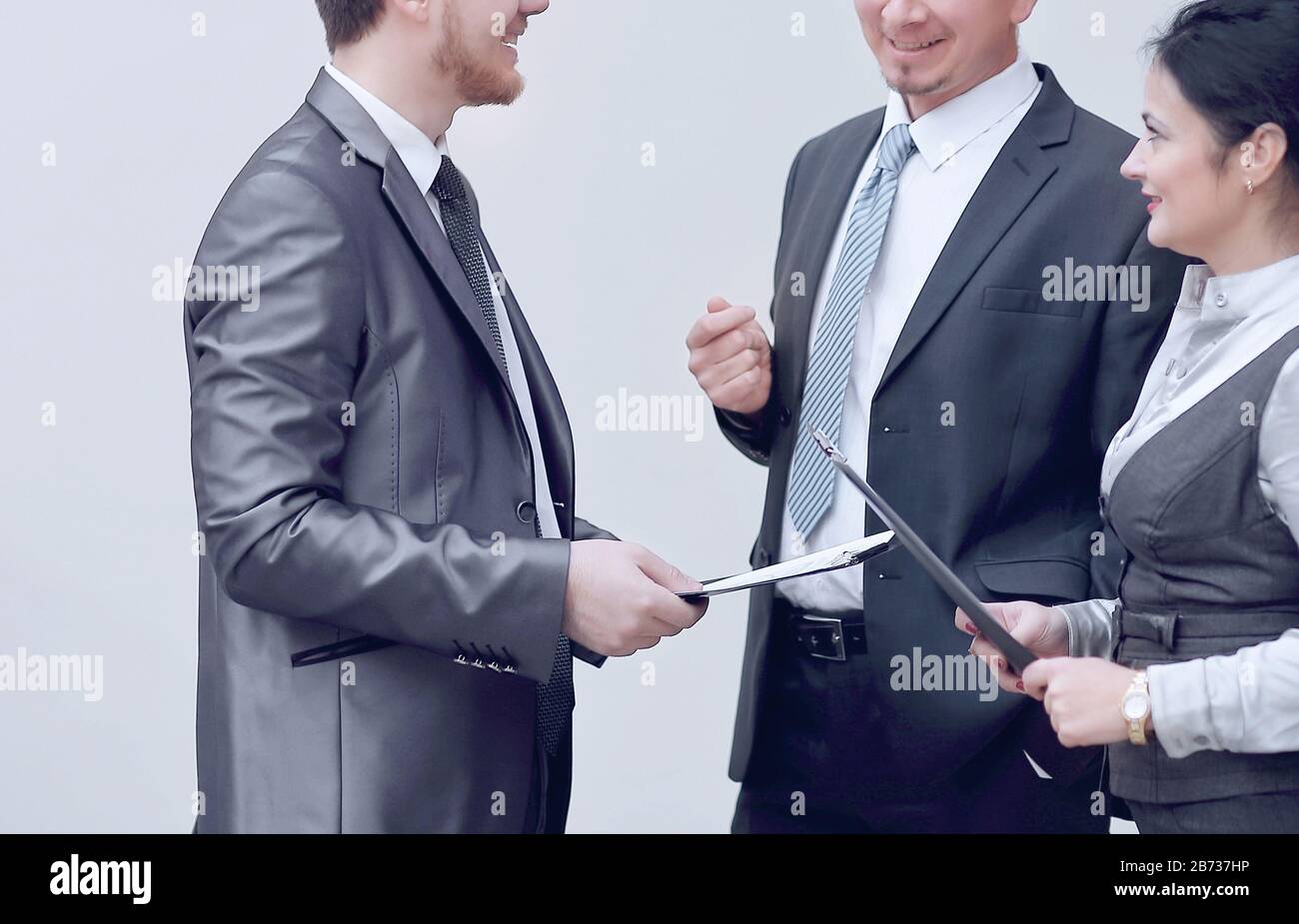business people discussion over documents in empty office Stock Photo ...