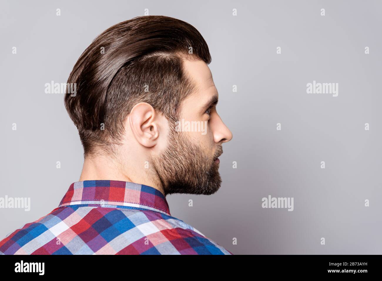 A half-face portrait of a handsome man with modern haircut isolated on ...