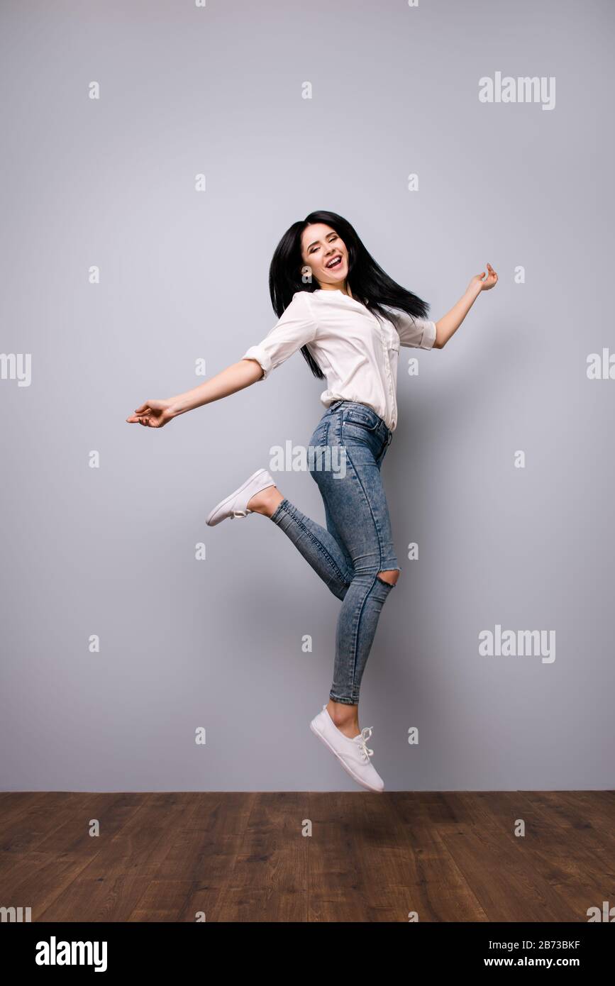 Full portrait of happy laughing jumping woman who is excited because of ...