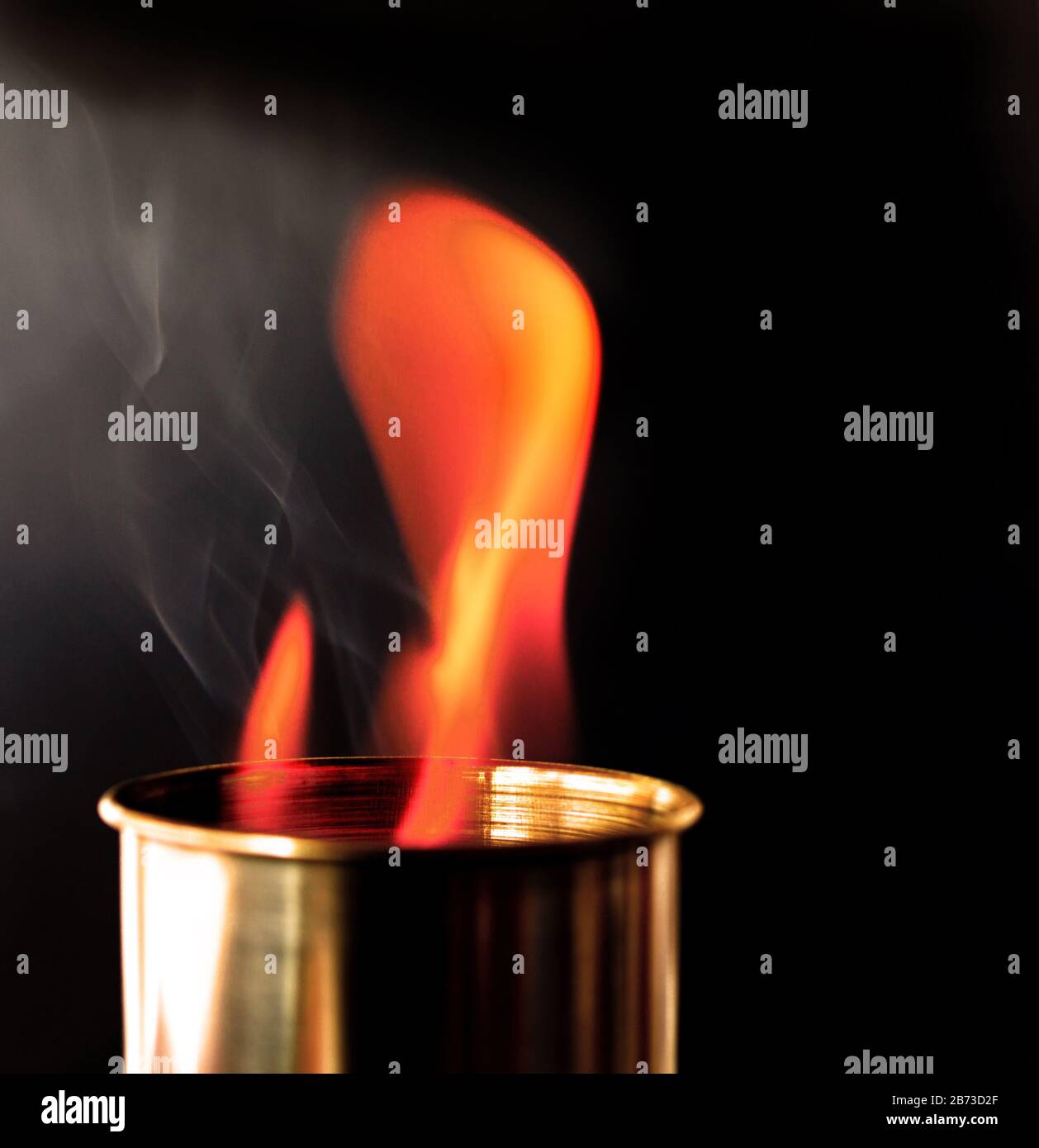 Flame, burning candle on a black background. Brass candle. Danger. Fire ...