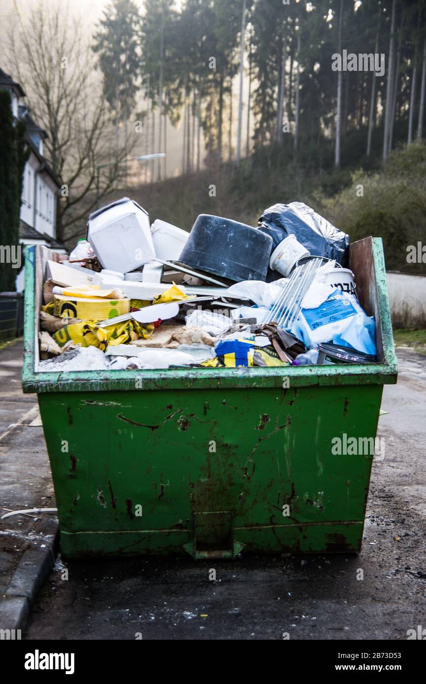 green rubble container with waste Stock Photo - Alamy