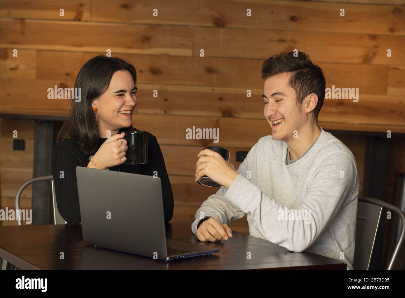 two persons working team drinking coffee Stock Photo - Alamy
