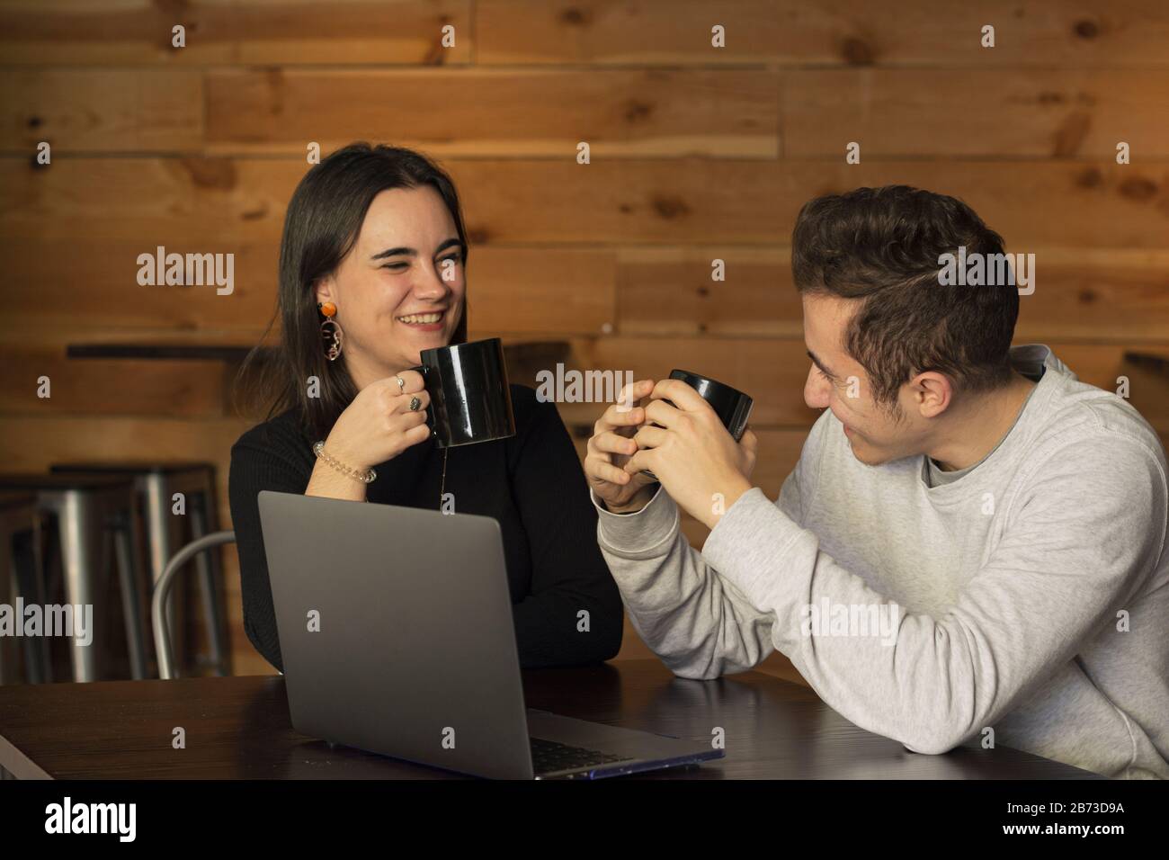 two persons working team drinking coffee Stock Photo - Alamy