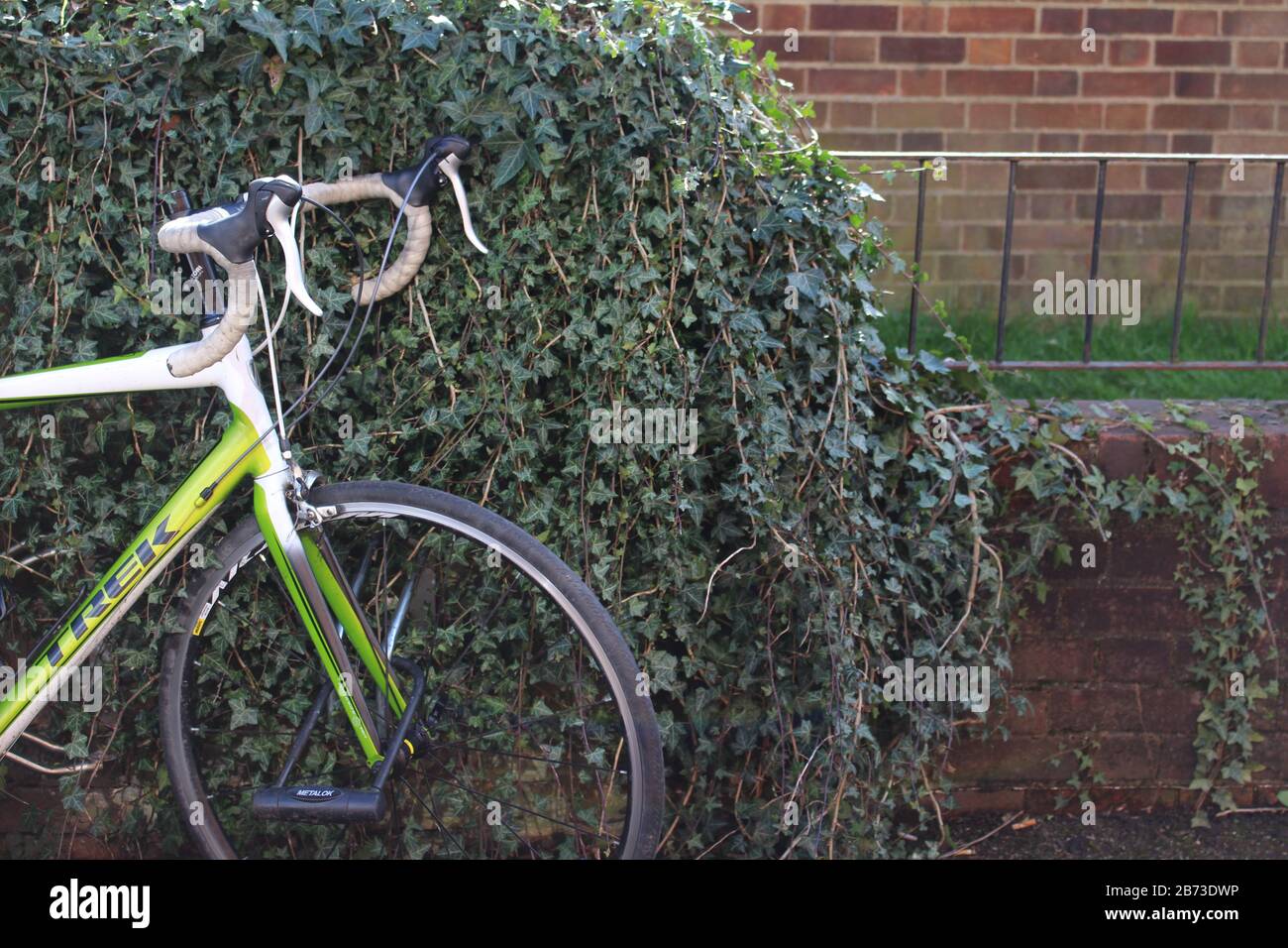 Red bicycle on fence hi-res stock photography and images - Alamy