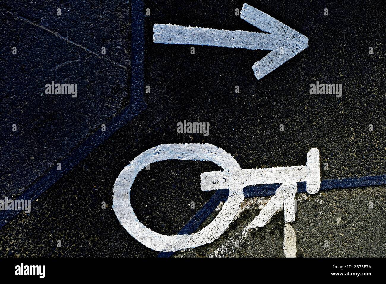 White direction and cycle road signs against tarmac Stock Photo - Alamy