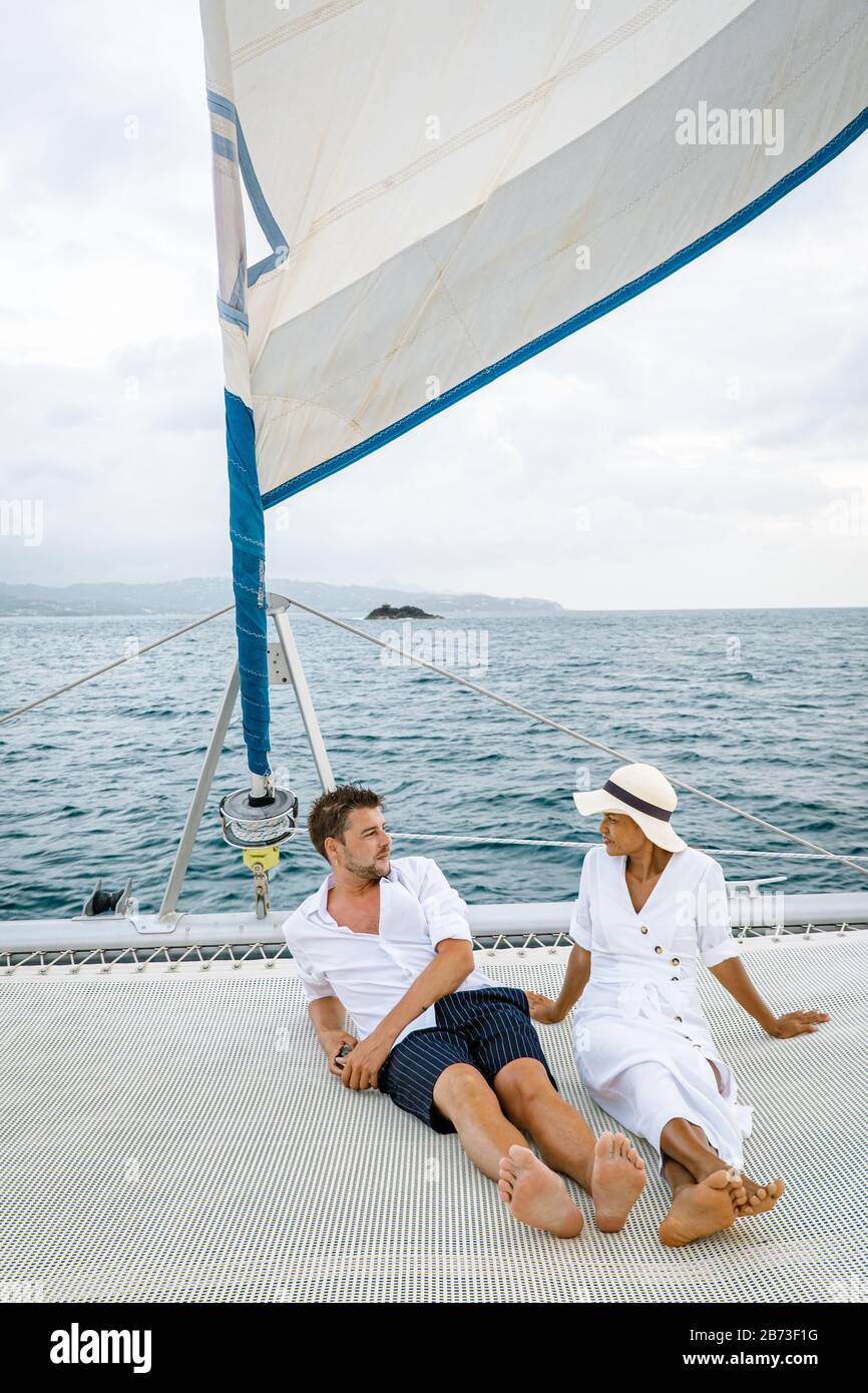 St Lucia, couple men and woman watching sunset from sailing boat in the ...