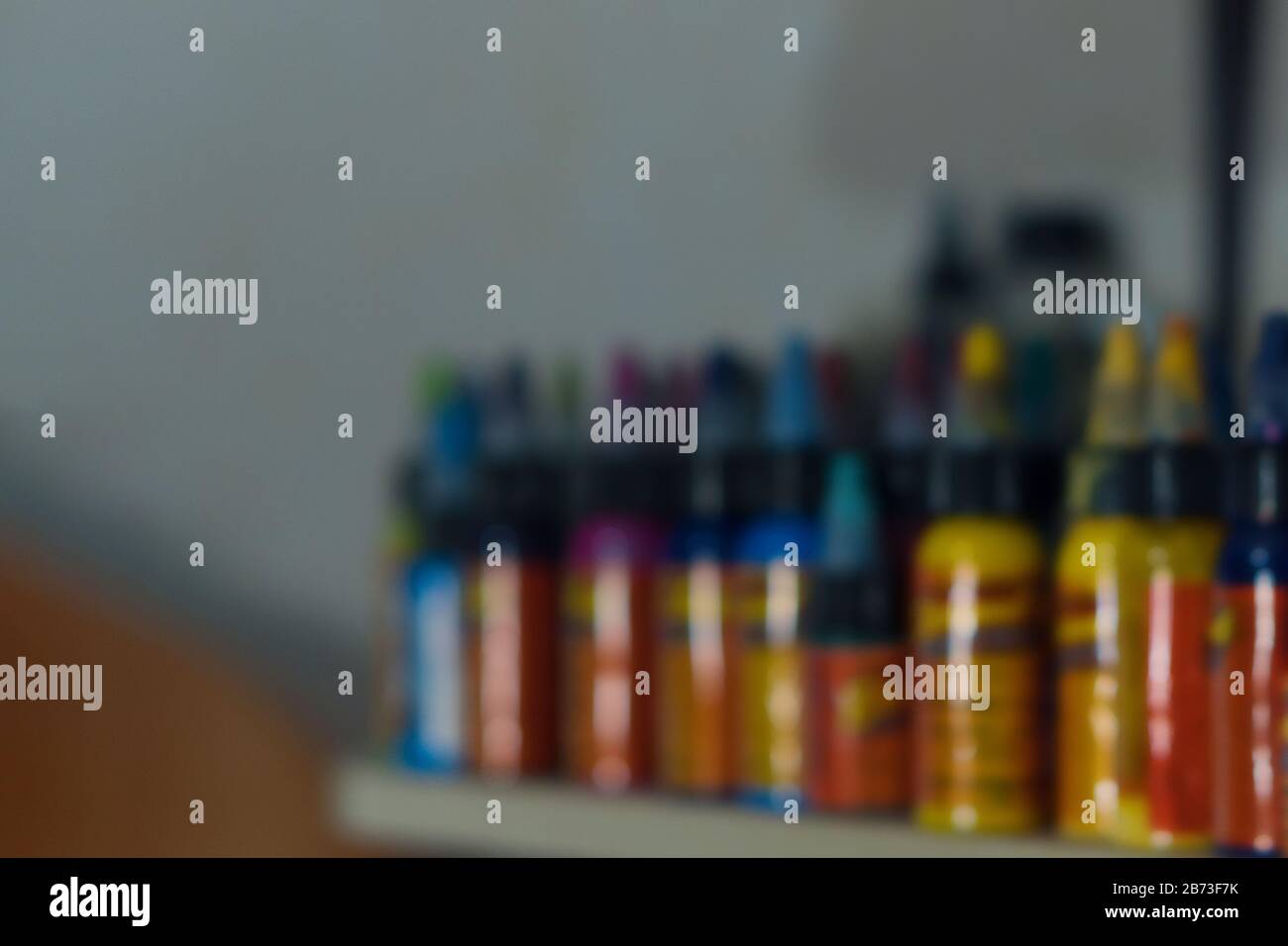 Many professional bottles with colored ink for tattoos. Background ...