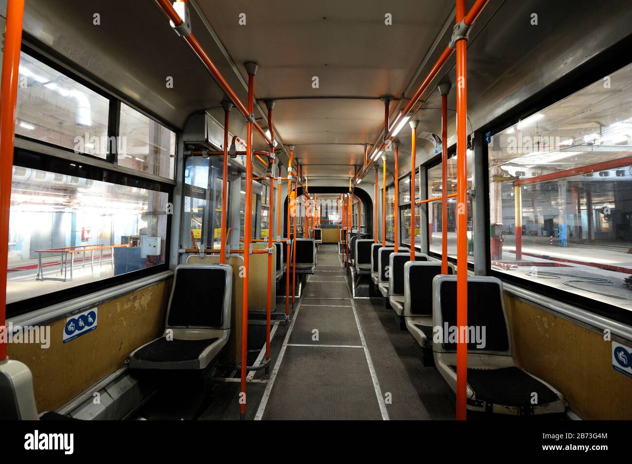 Interior of the modern trolleybus, blue seats, orange handrails ...