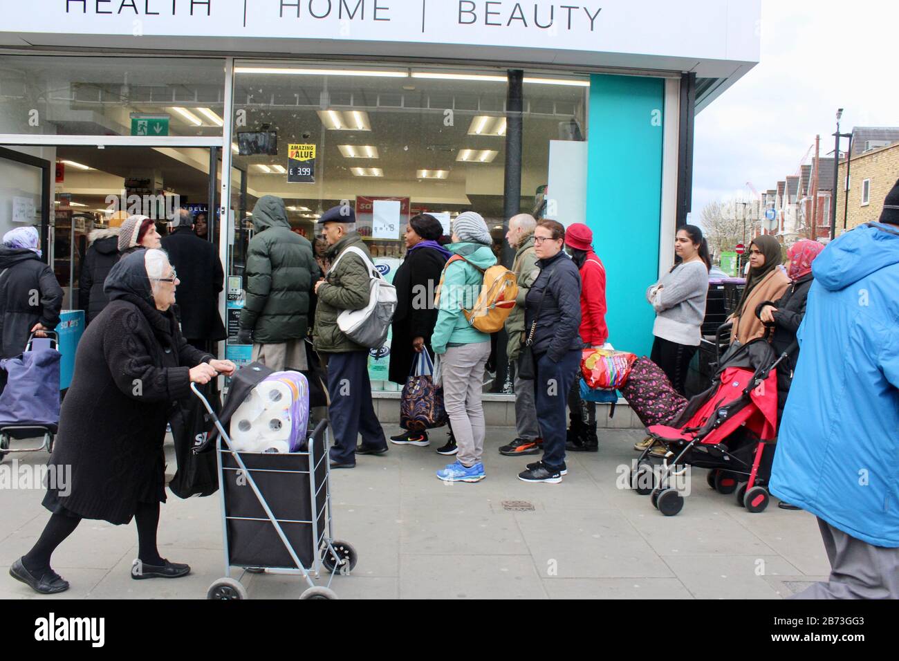 queue of people waiting to buy toilet paper wood green high road london ...
