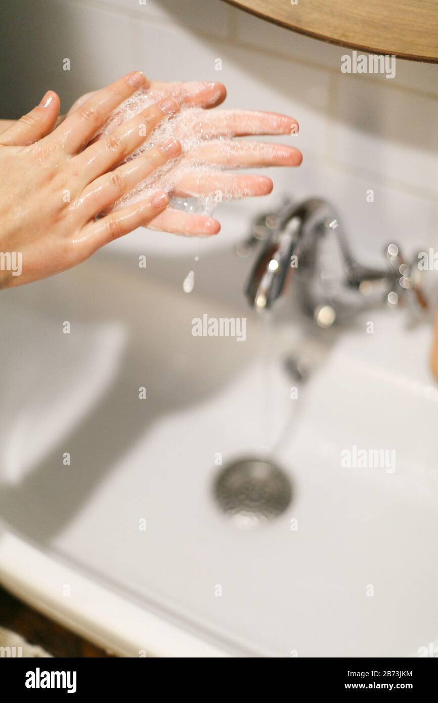 Washing hands. Hands washing with soap foam on background of flowing ...