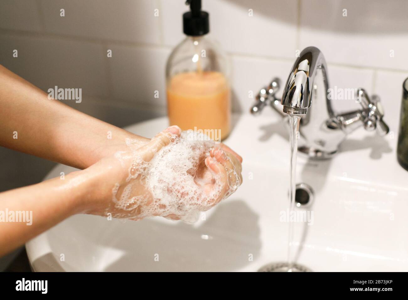 Washing hands. Hands washing with soap foam on background of flowing ...