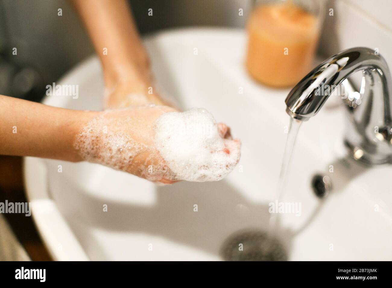 Washing hands. Hands washing with soap foam on background of flowing ...
