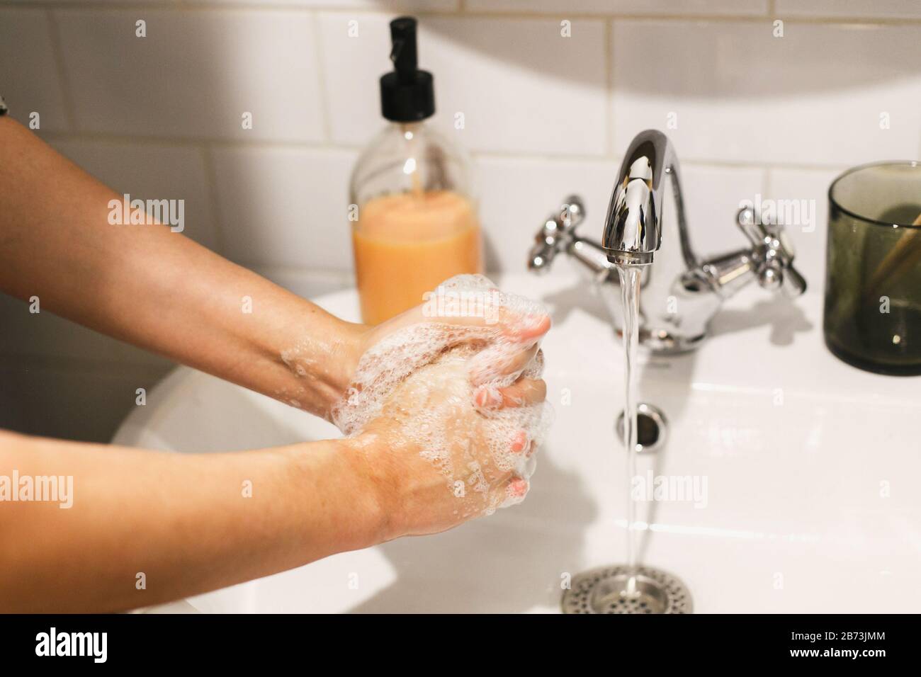 Washing hands. Hands washing with soap foam on background of flowing ...
