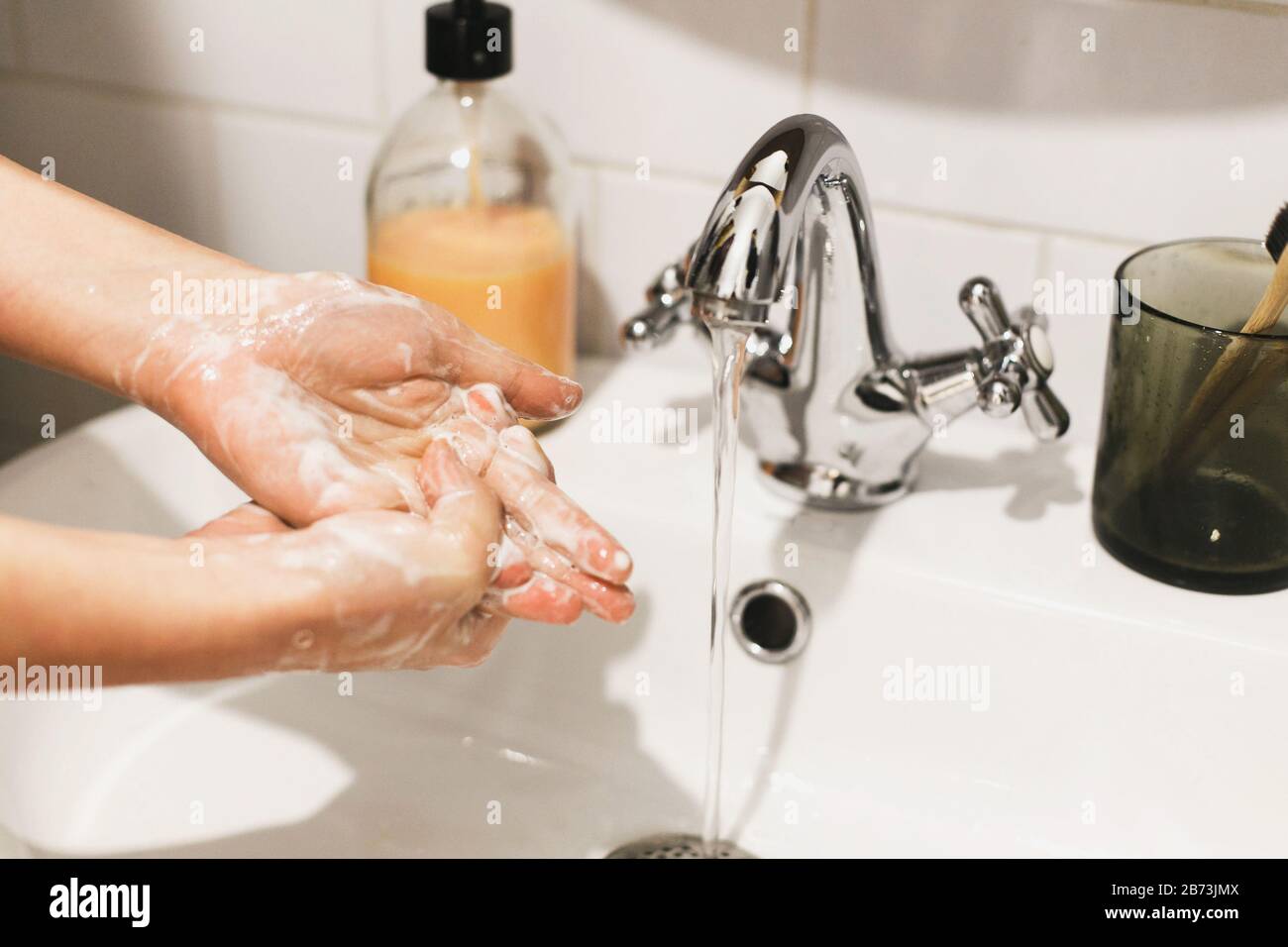 Washing hands. Hands washing with soap foam on background of flowing ...