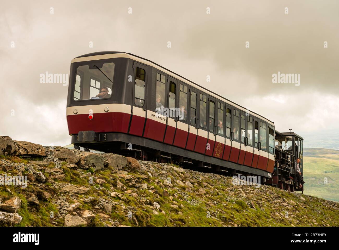 Diesel locomotive, "Yeti" (1986) pushes a carriage of tourists up the Snowdon Mountain Railway ...