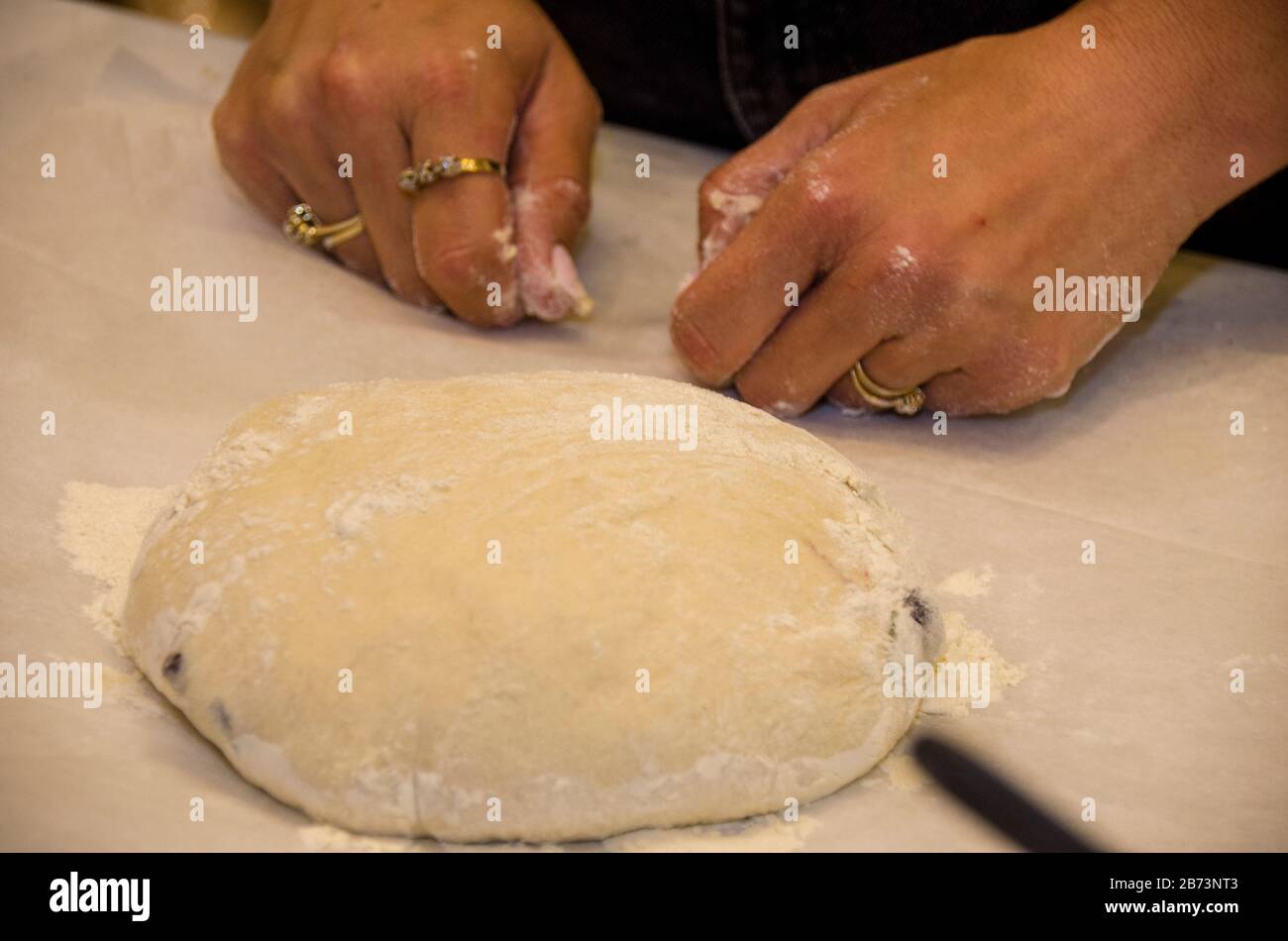 close up of the Hands of a female pastry chef as she demonstrates how ...