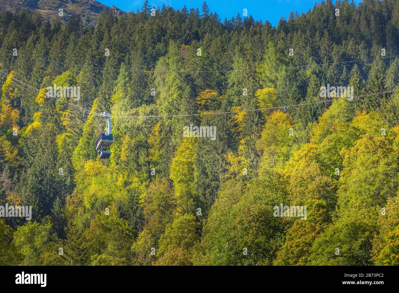 Lauterbrunnen, Switzerland - October 10, 2019: Autumn forest and blue ...