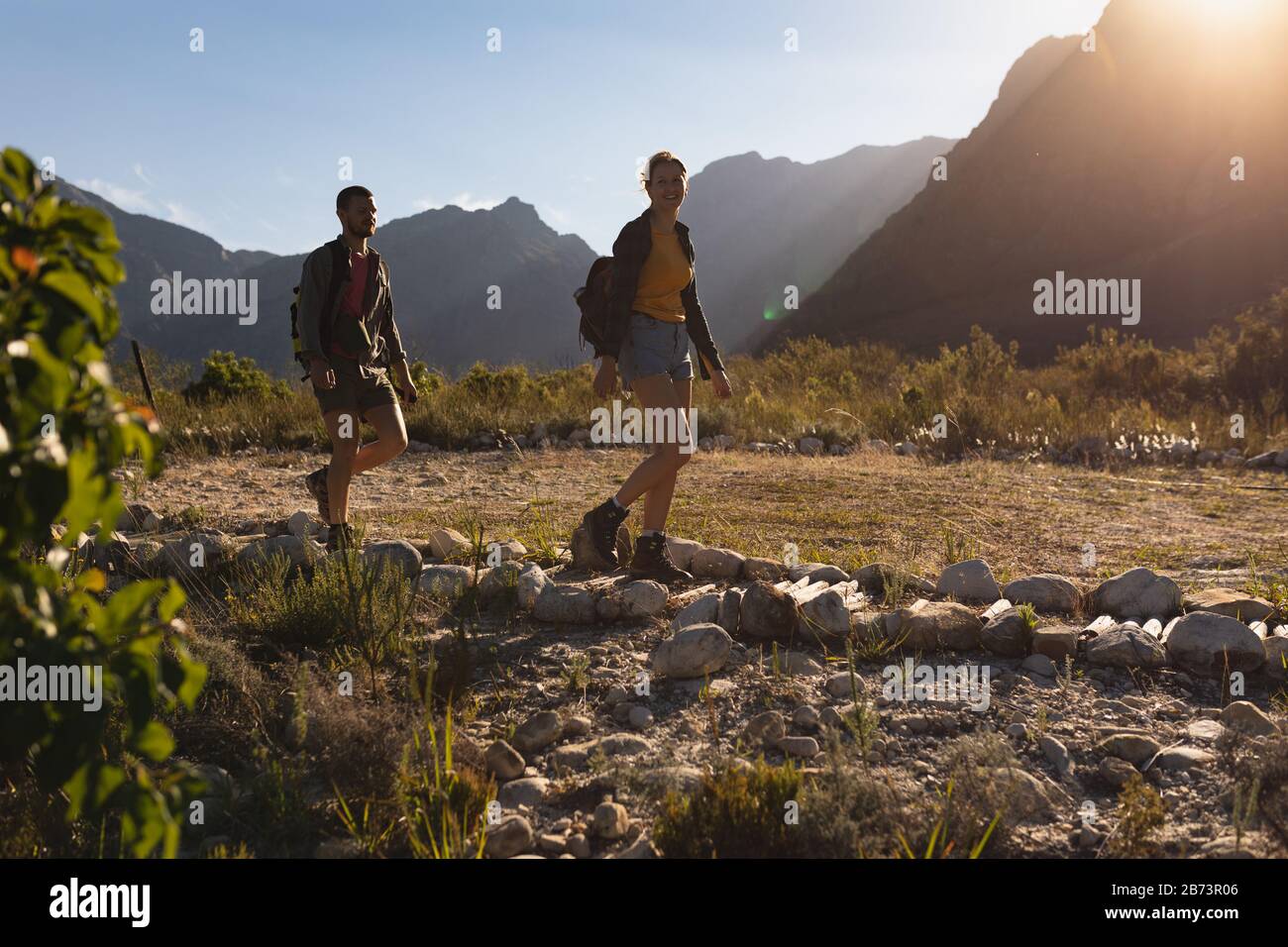 Side view of couple walking on a path Stock Photo - Alamy