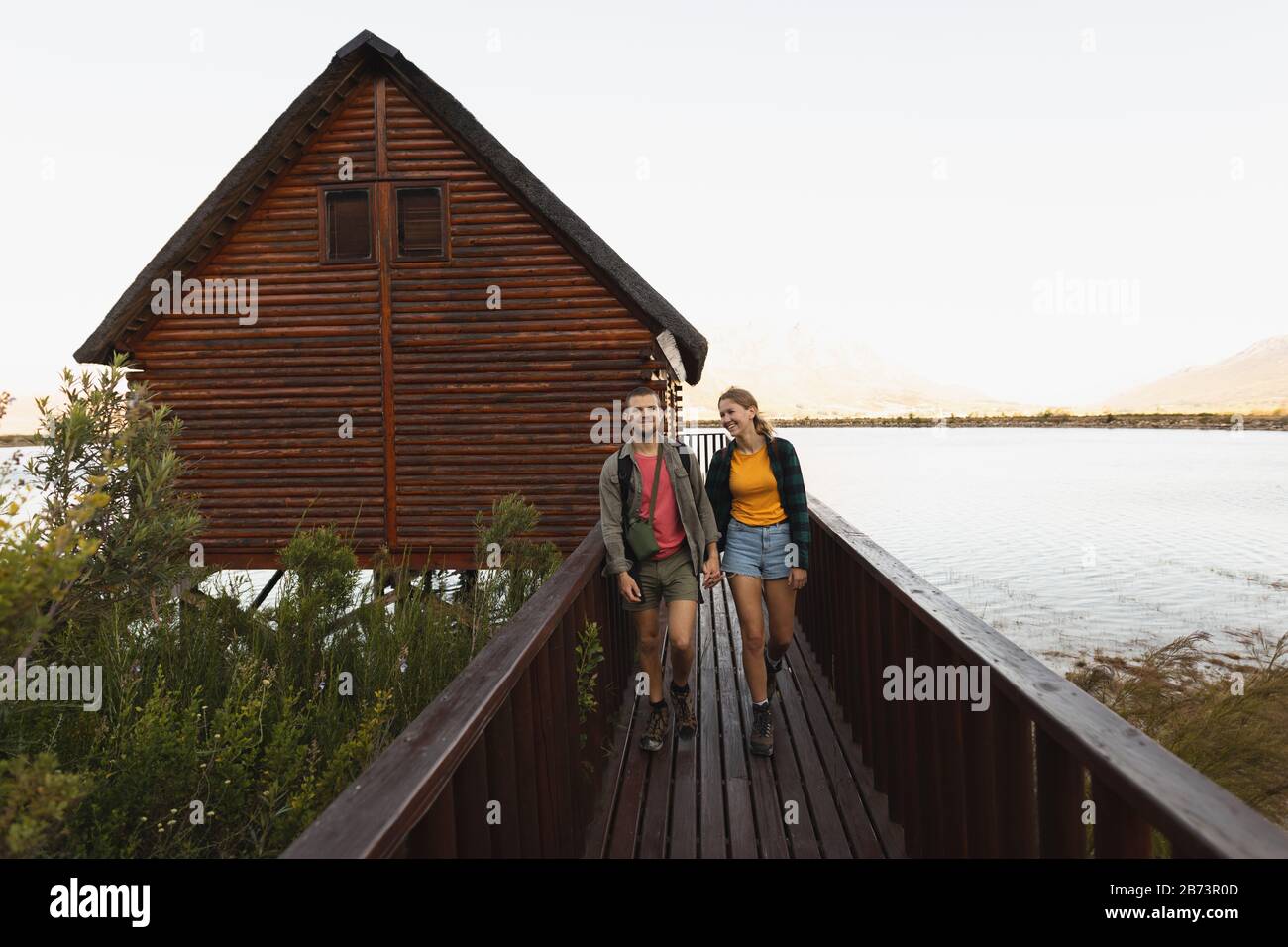 Front view of couple walking and holding hands Stock Photo - Alamy