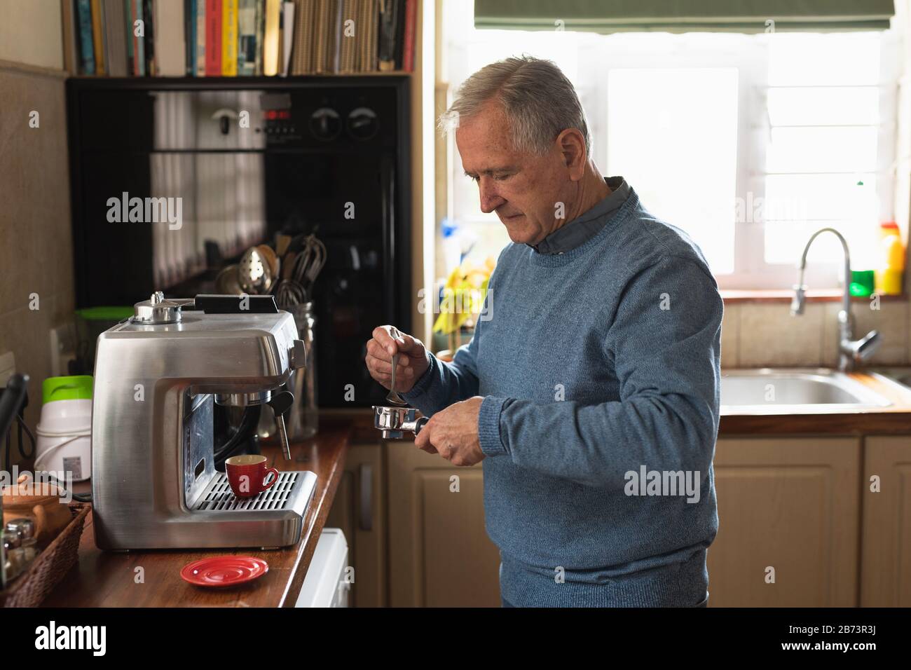 Senior man making coffee in his kitchen Stock Photo - Alamy