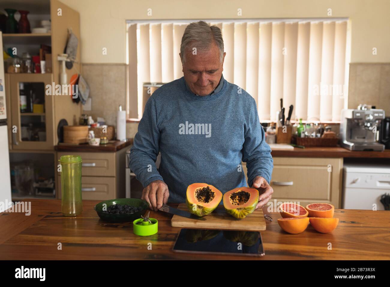Senior man cooking on his kitchen Stock Photo - Alamy