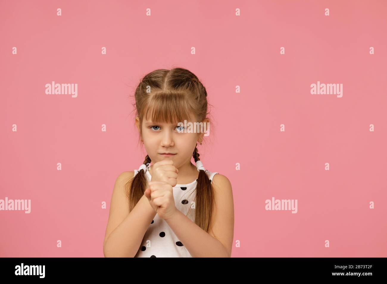 angry little child girl in dress raising fist frustrated and furious ...