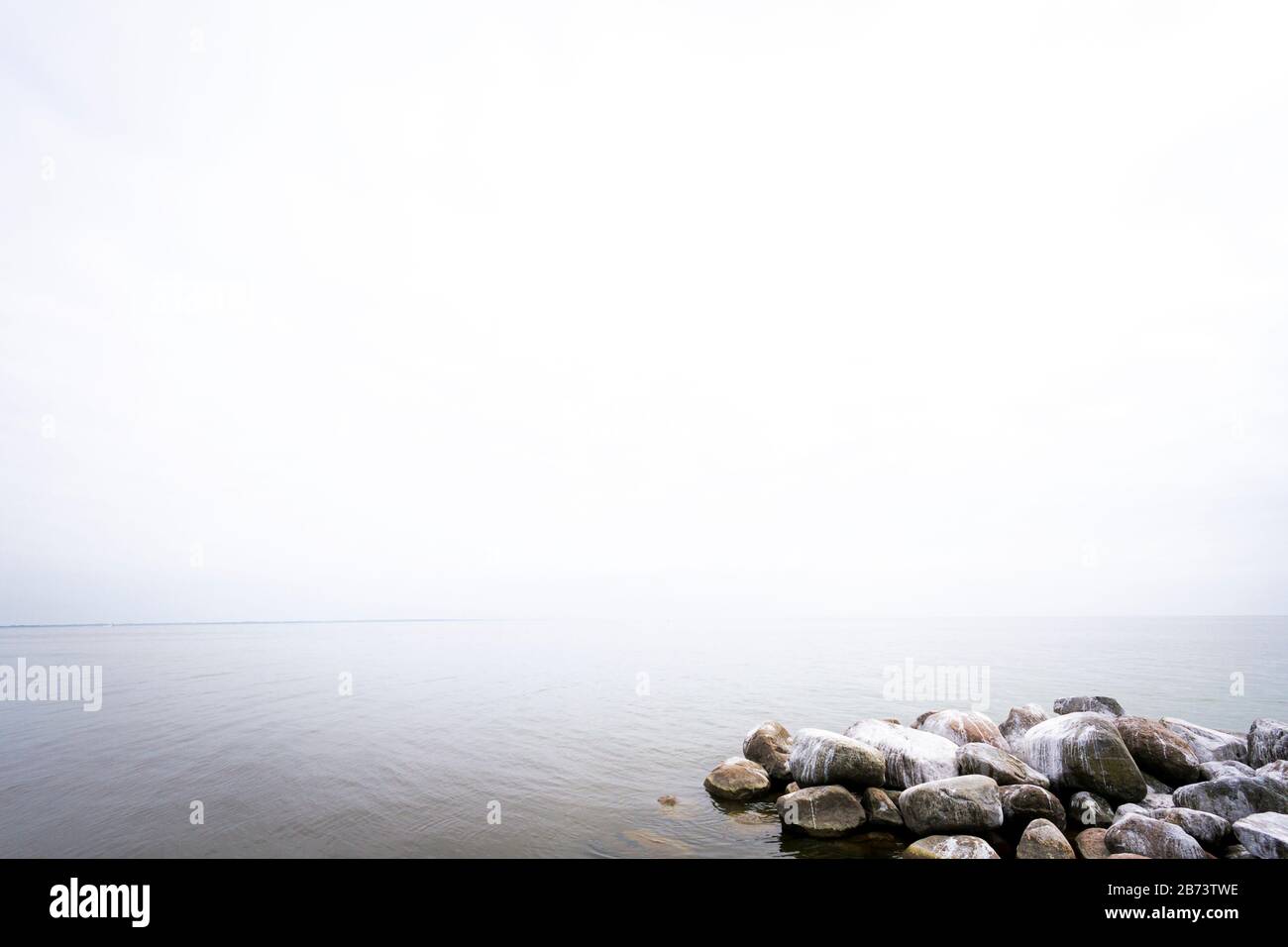 Sea with a stones in the water Stock Photo - Alamy