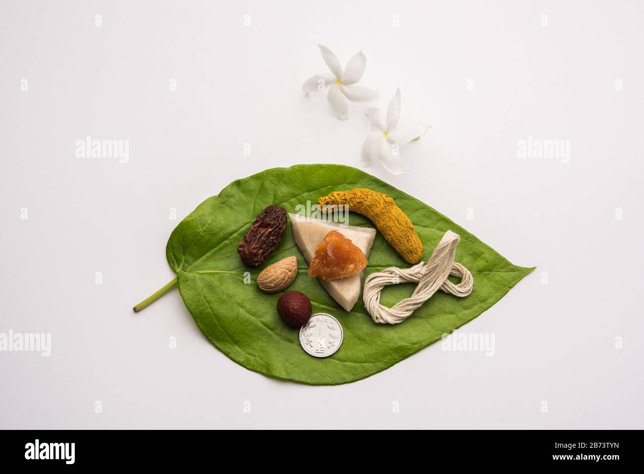 Hindu Puja with betel leaf, supari, janeu, almond, dates, turmeric ...