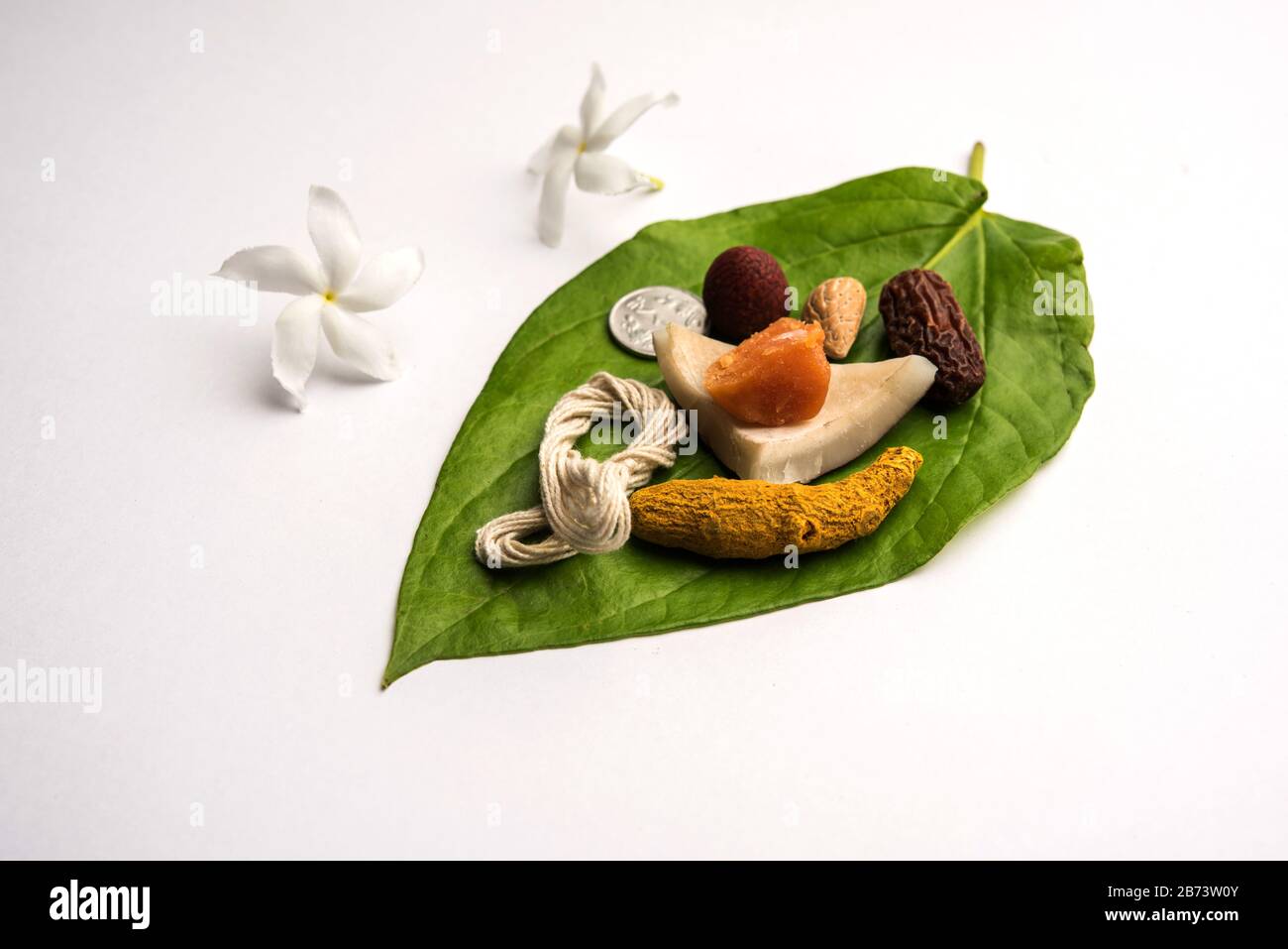 Hindu Puja with betel leaf, supari, janeu, almond, dates, turmeric ...