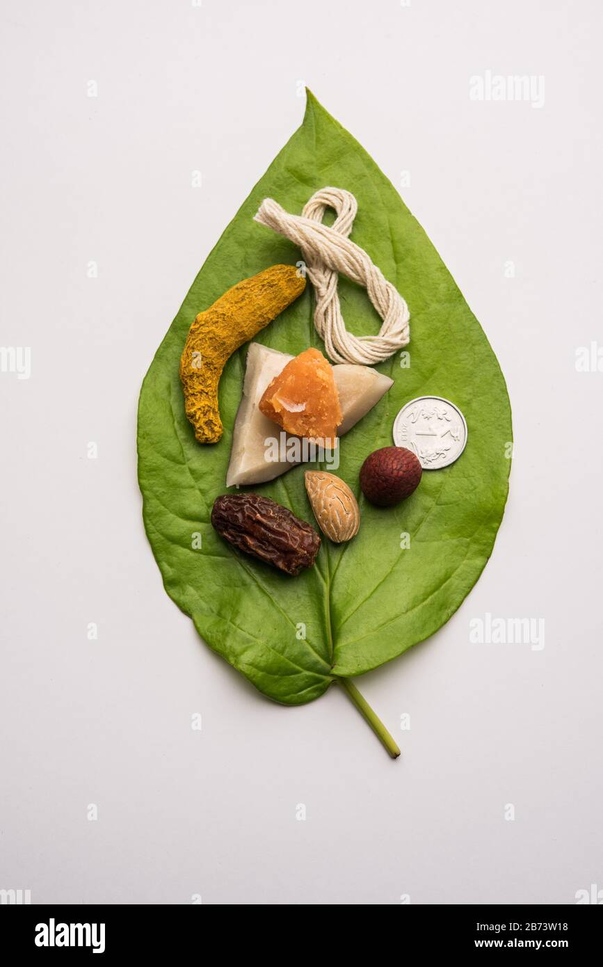 Hindu Puja with betel leaf, supari, janeu, almond, dates, turmeric ...