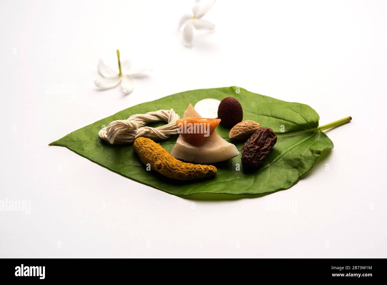 Hindu Puja with betel leaf, supari, janeu, almond, dates, turmeric ...