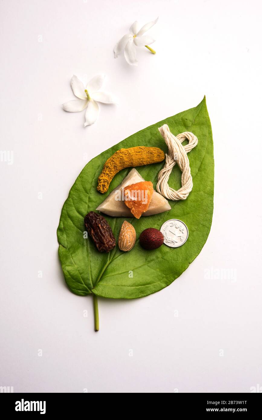 Hindu Puja with betel leaf, supari, janeu, almond, dates, turmeric ...