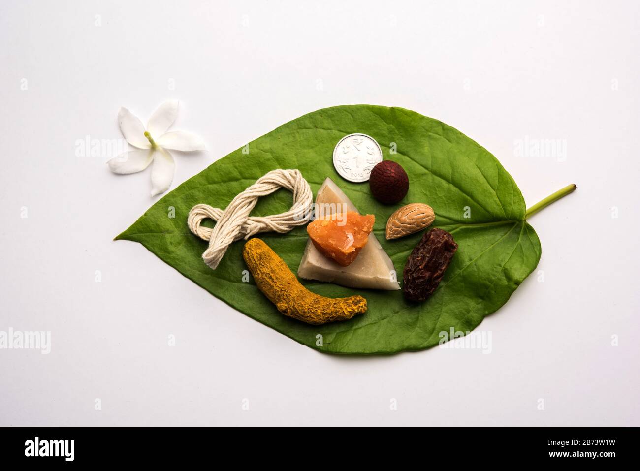 Hindu Puja with betel leaf, supari, janeu, almond, dates, turmeric ...
