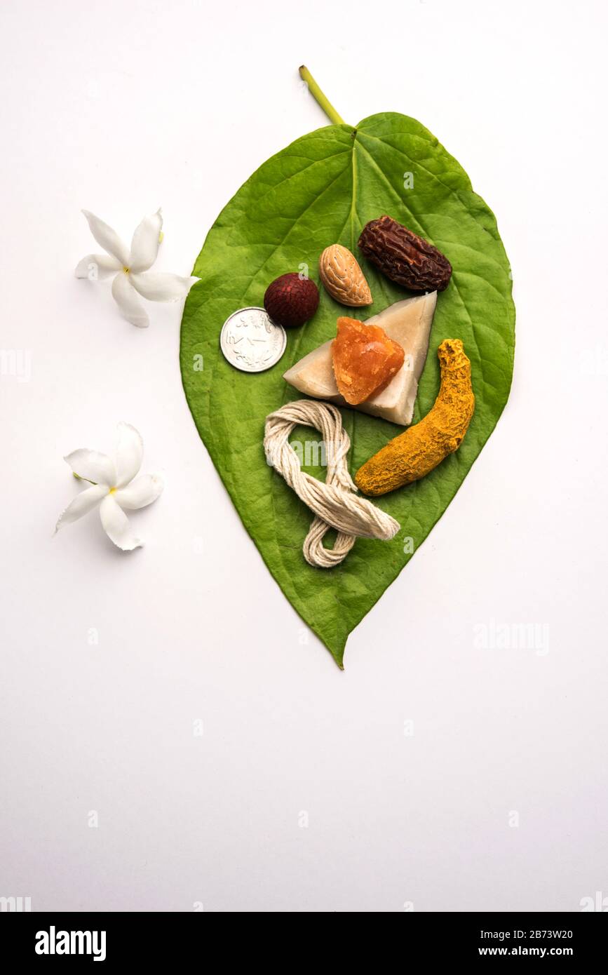 Hindu Puja with betel leaf, supari, janeu, almond, dates, turmeric ...
