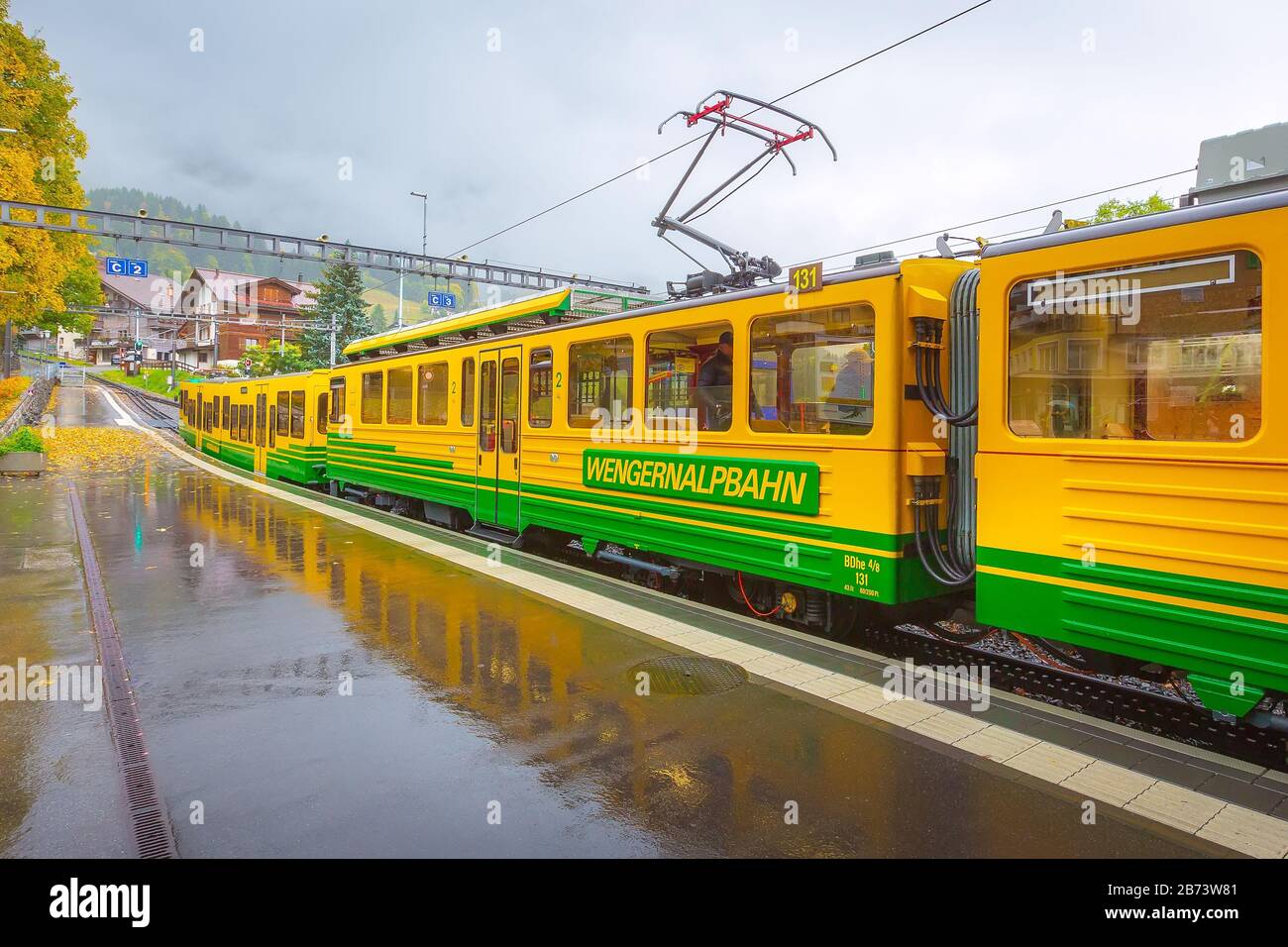 Wengen, Switzerland - October 10, 2019 : Green and yellow train of the ...