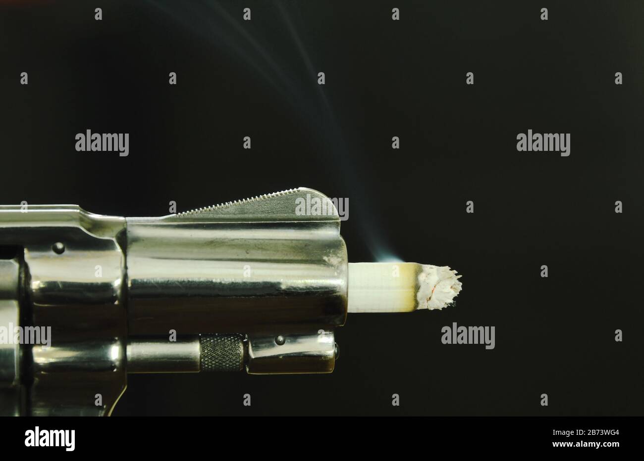 Cigarette fire in gun muzzle compared smoking can kills Stock Photo - Alamy