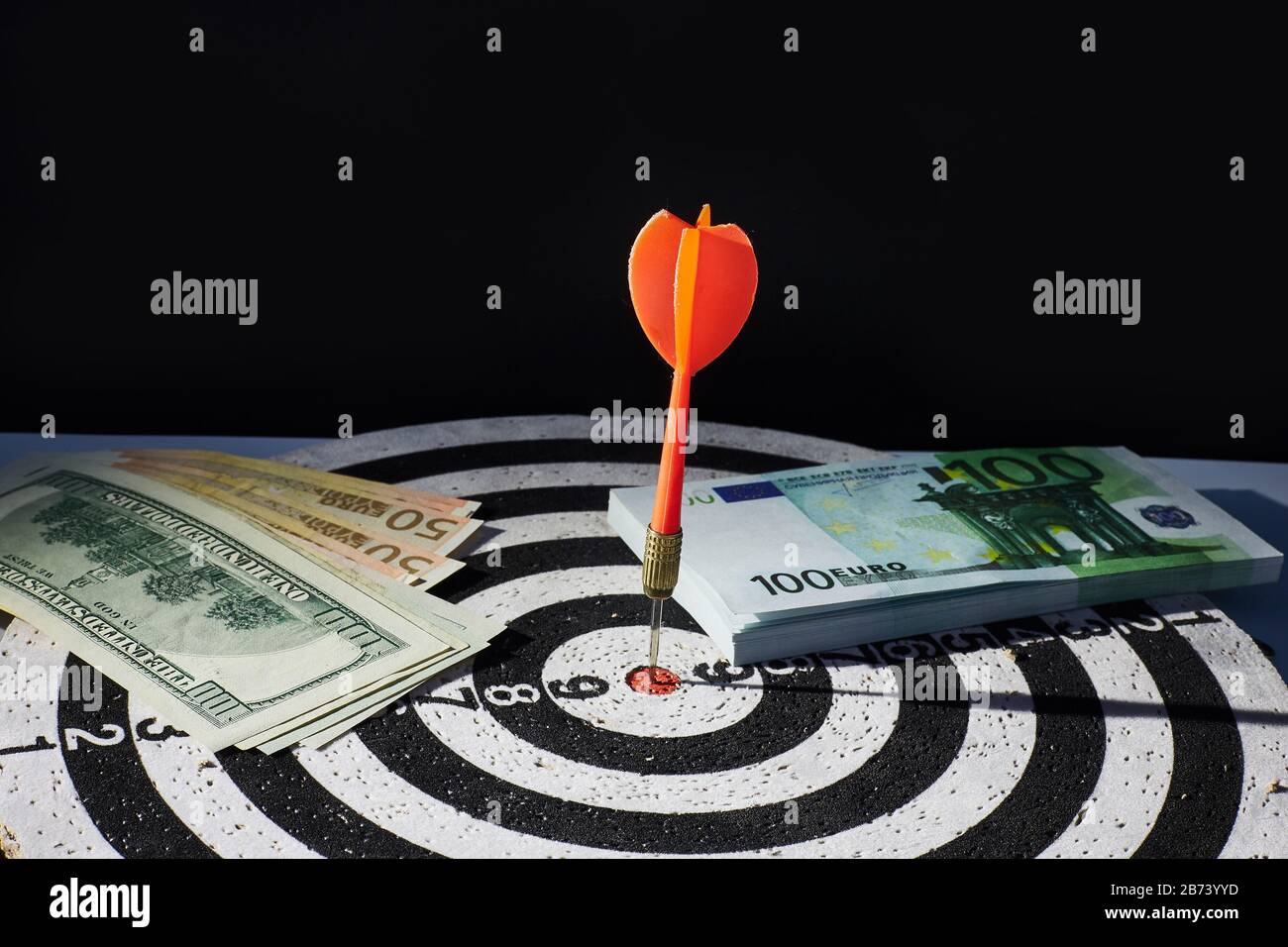 Business concept of money and goal achievement. Darts, cash banknotes ...