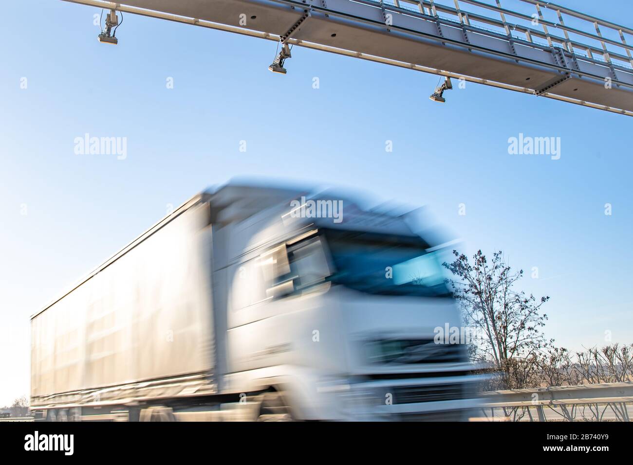 truck drive through the highway through the toll gate, toll charges ...