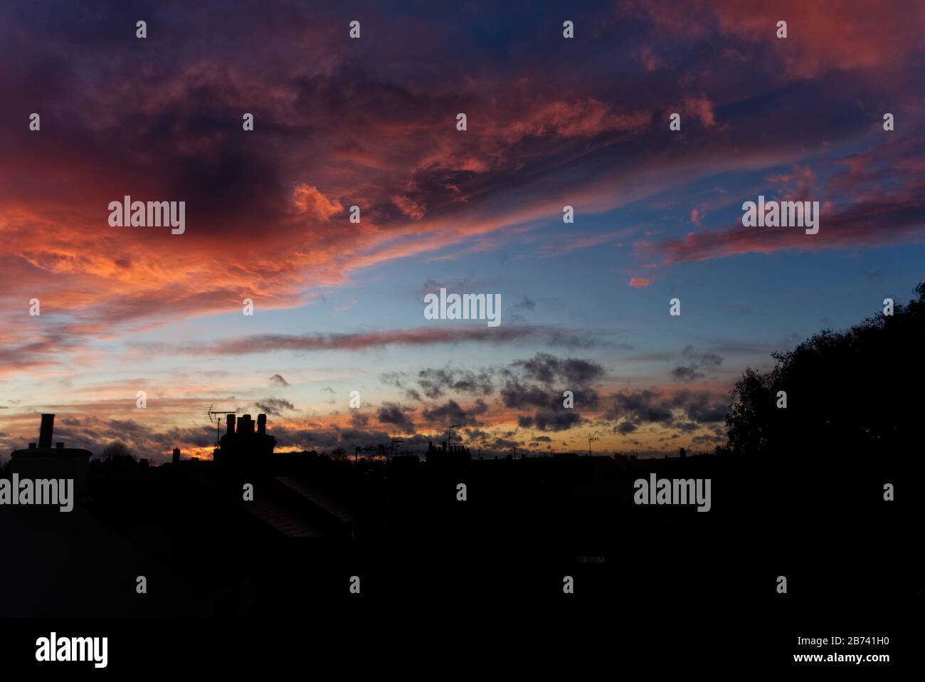 Sunset on horizon above city building Stock Photo - Alamy