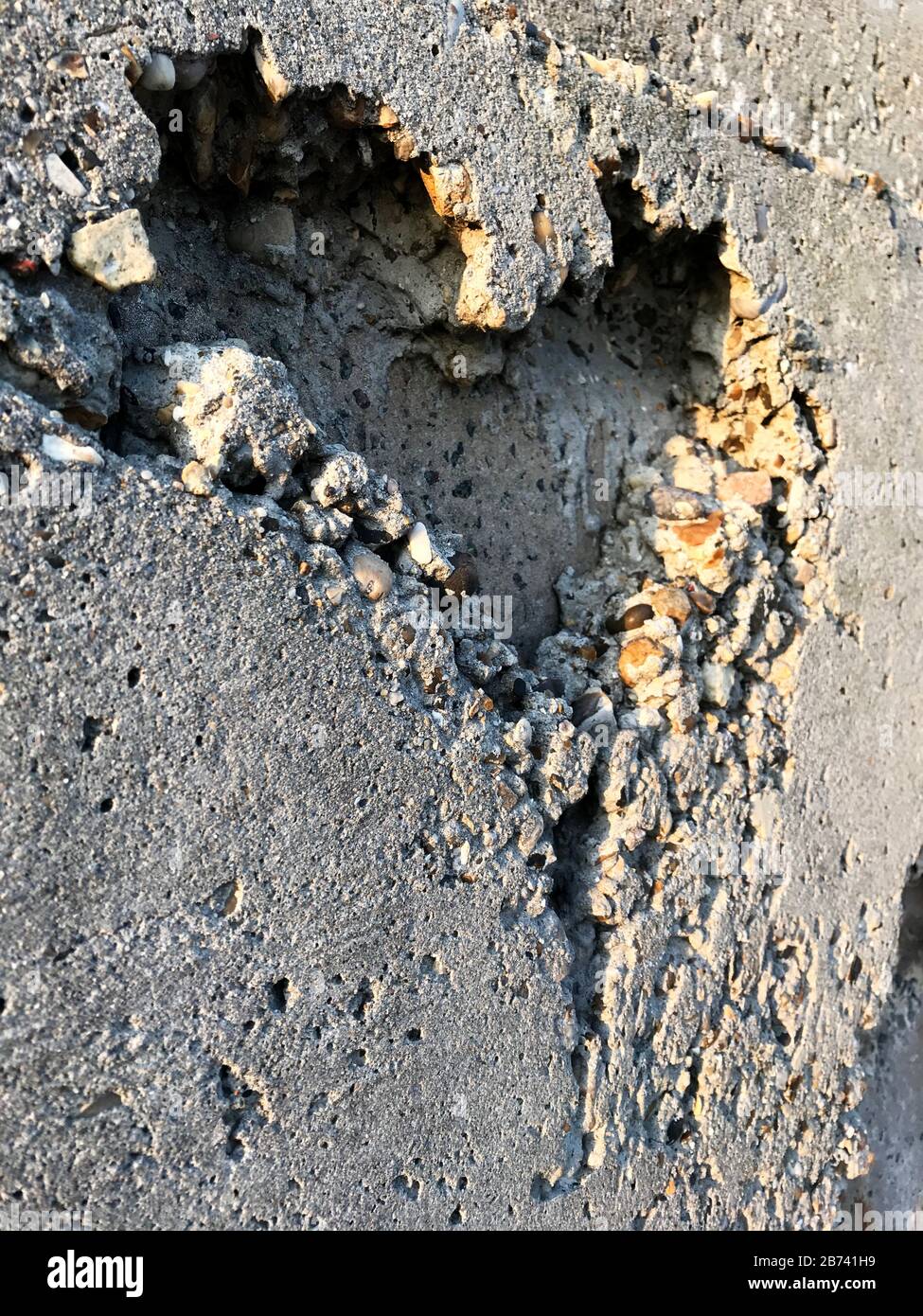 a heart-shaped trail on the beach wall Stock Photo - Alamy