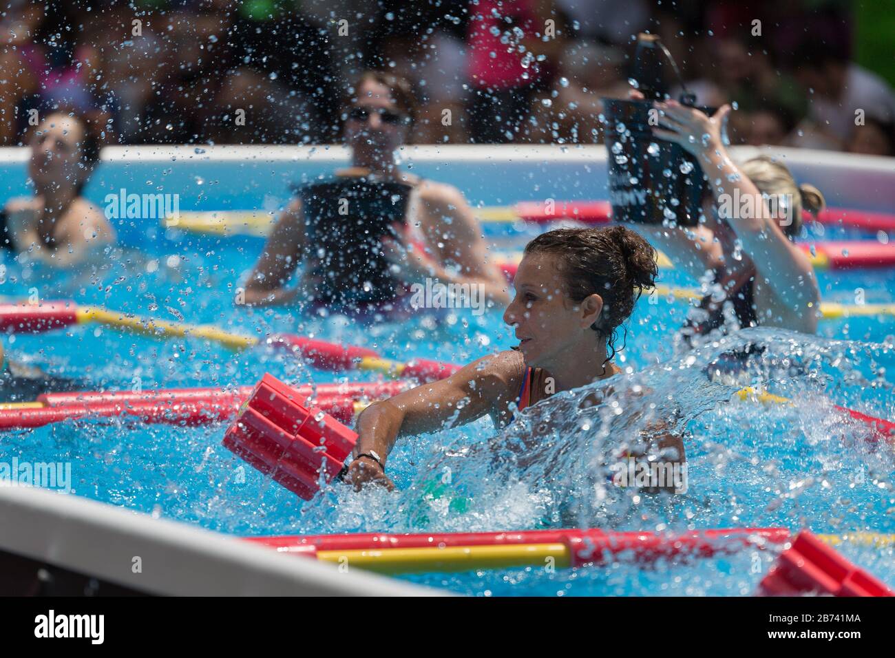 Girls Doing Water Aerobics with Floating Pool Dumbbells Outdoor in a ...