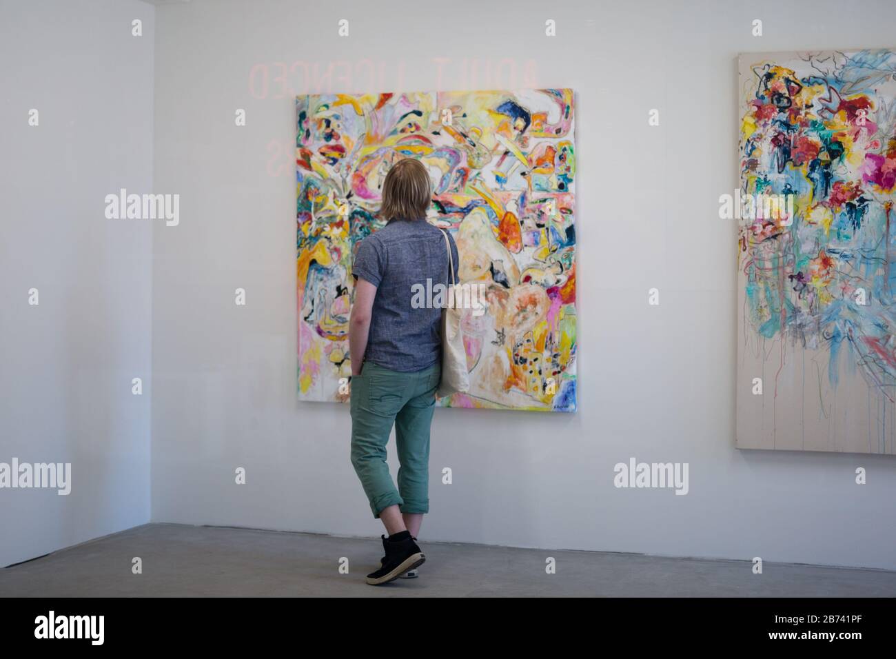 Boy Looking at an Abstract Painting in an Art Gallery Stock Photo - Alamy